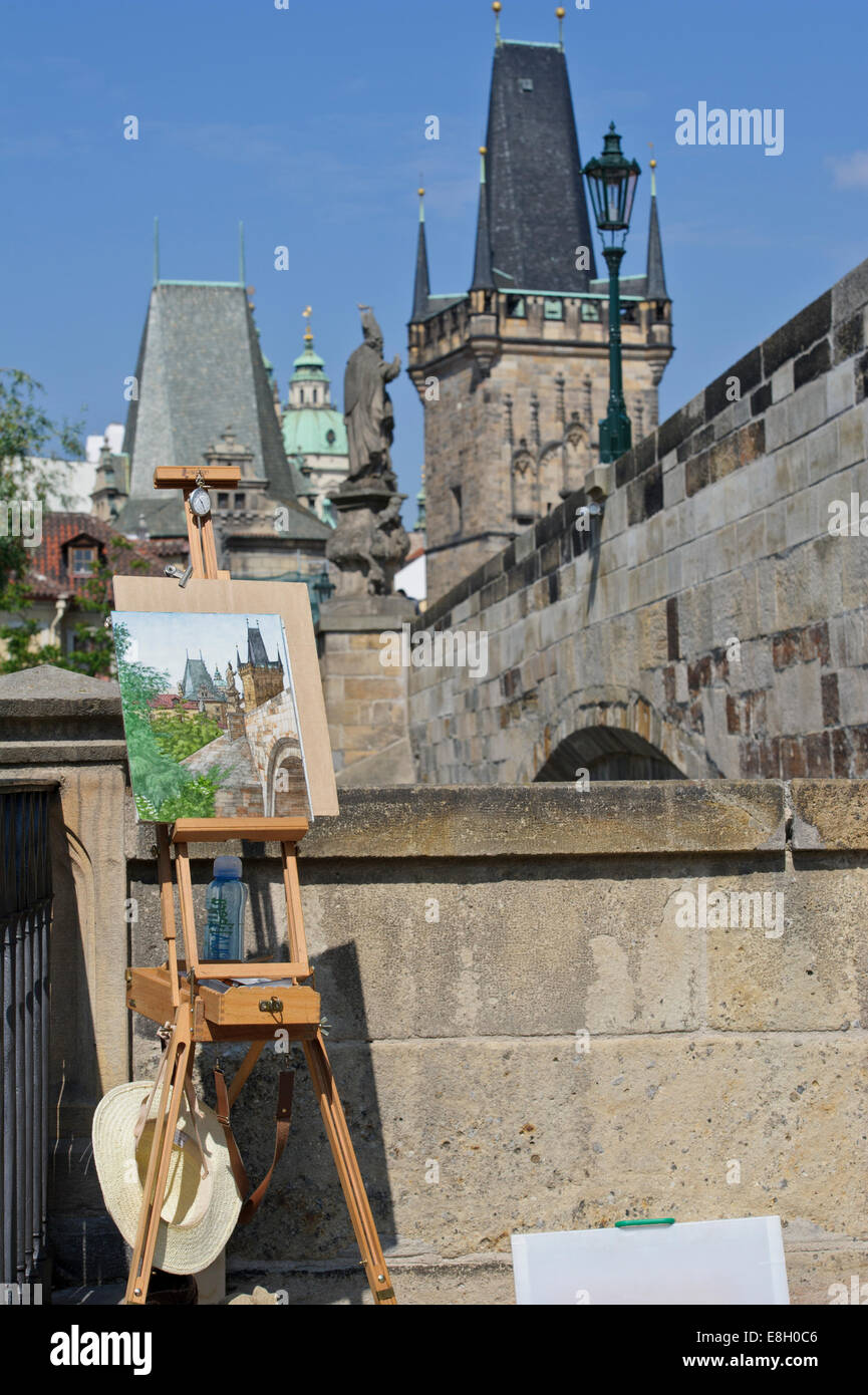 A water colour painting of Charles bridge on easel mirroring the actual ...