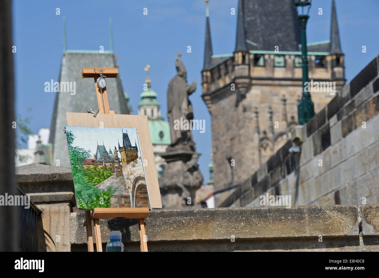 A water colour painting of Charles bridge on easel mirroring the actual ...