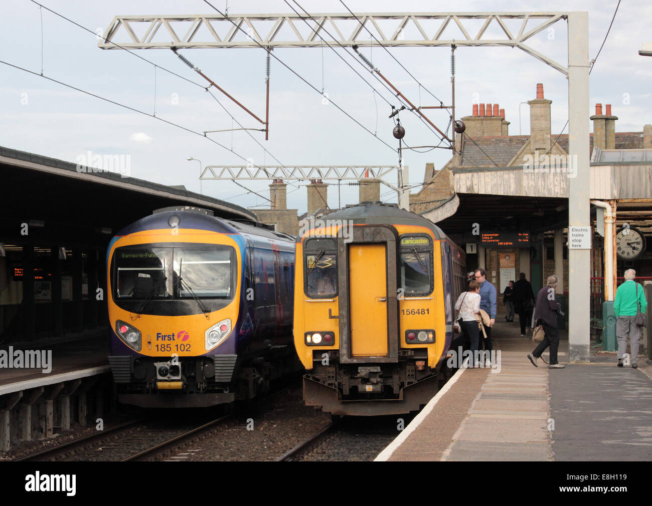 Two passenger trains in Carnforth station, a First Trans Pennine ...