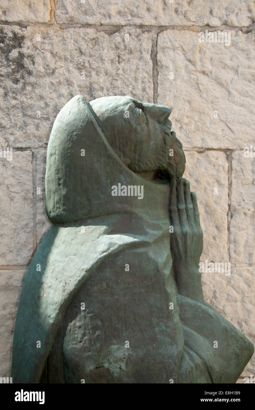 Bronze statue of a monk praying Stock Photo - Alamy