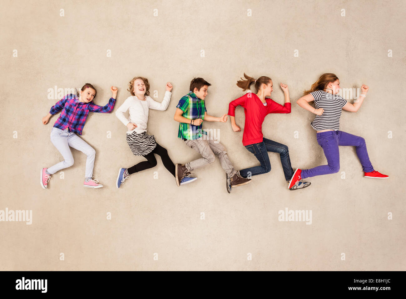 Group of children running in the same direction Stock Photo - Alamy