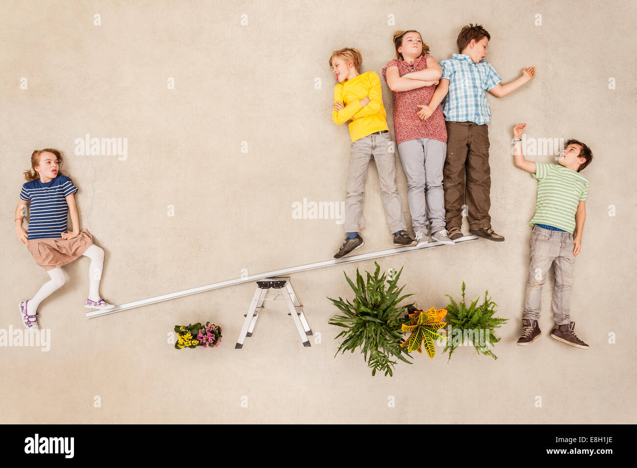 Children on seesaw in park Stock Photo - Alamy