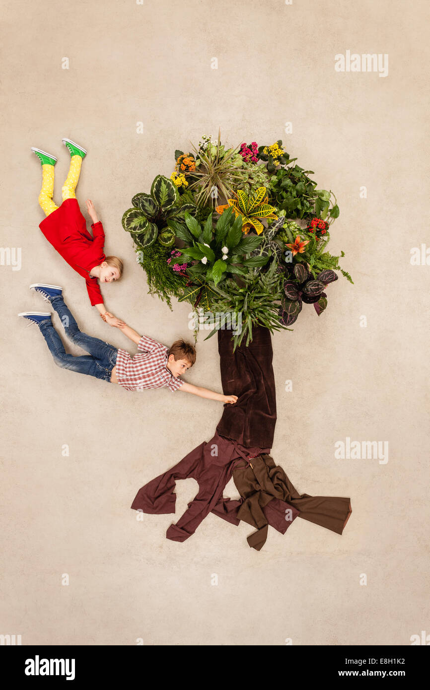 Boy and girl holding onto tree Stock Photo - Alamy