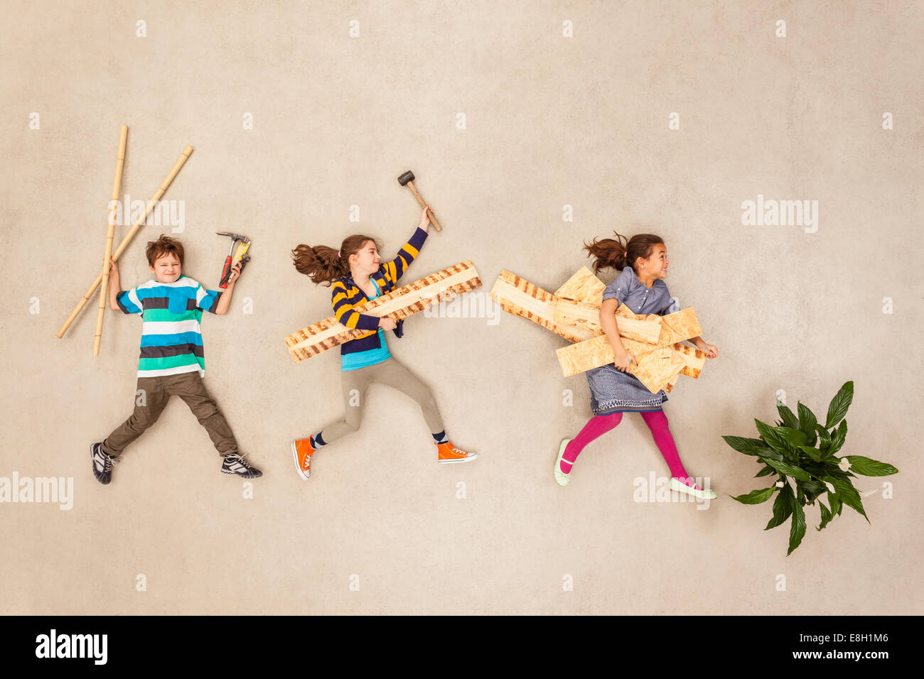 Children carrying building materials hi-res stock photography and ...