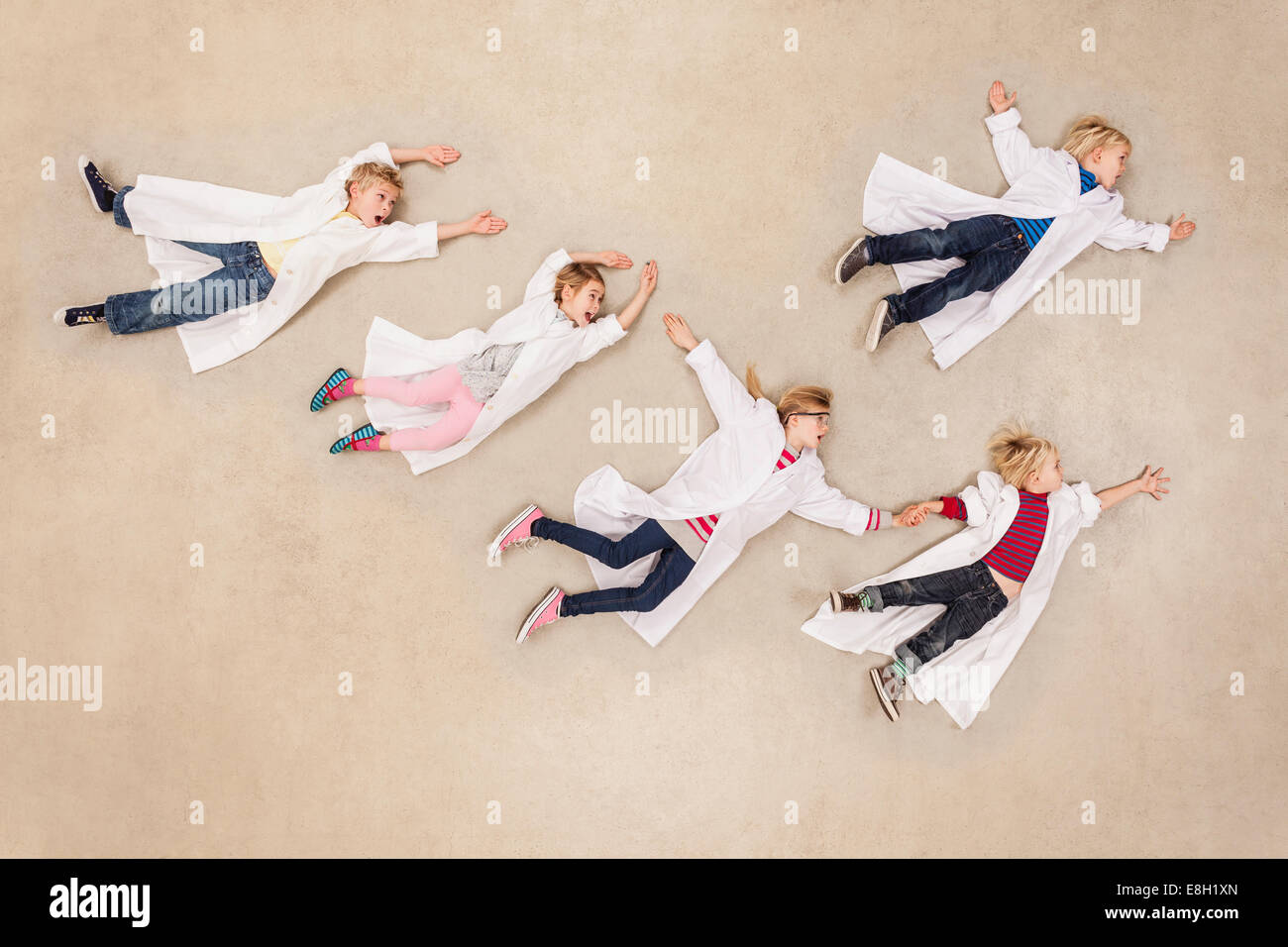 Flying children wearing laboratory coats Stock Photo - Alamy