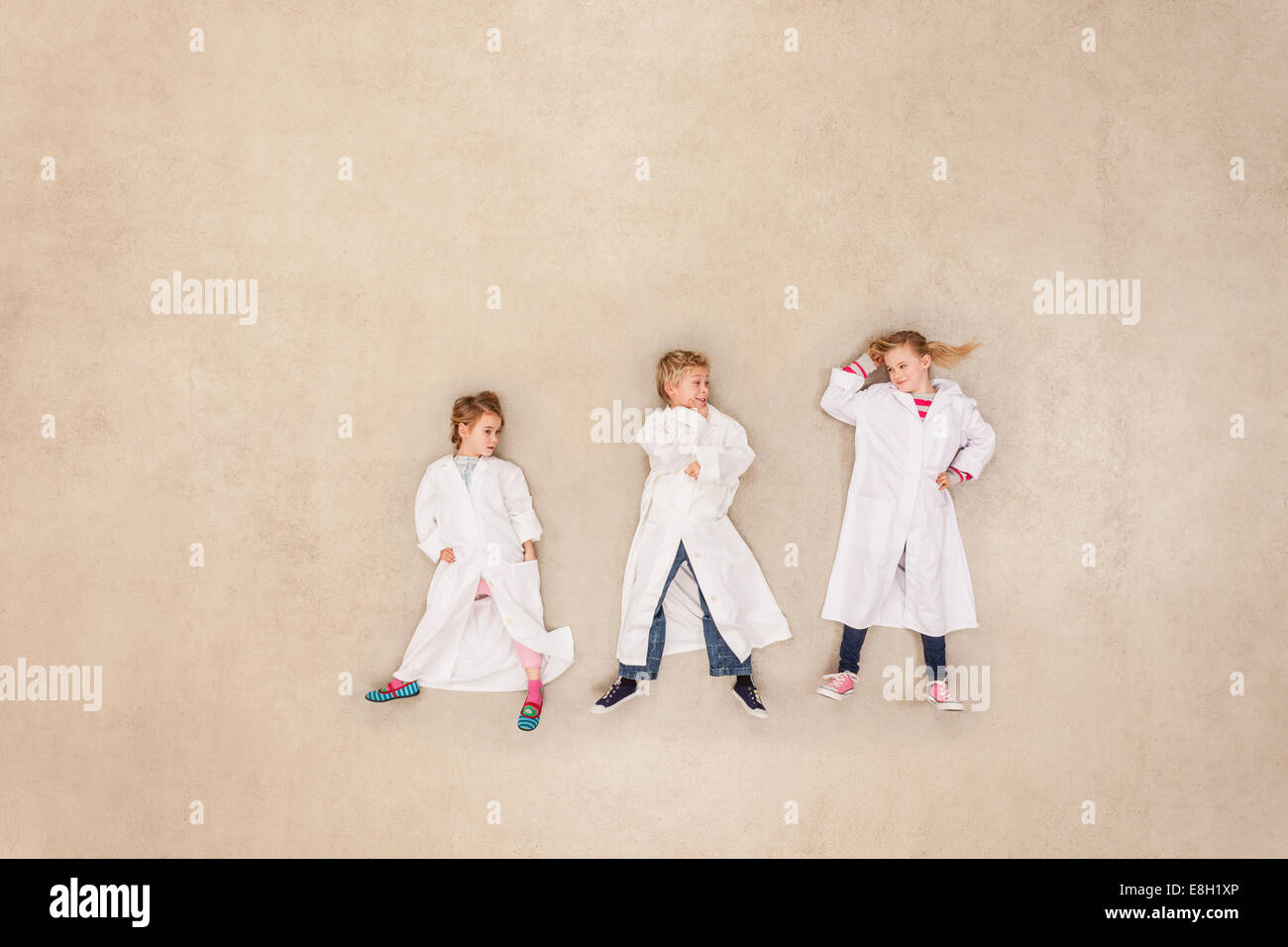 Children wearing laboratory coats doing research Stock Photo - Alamy