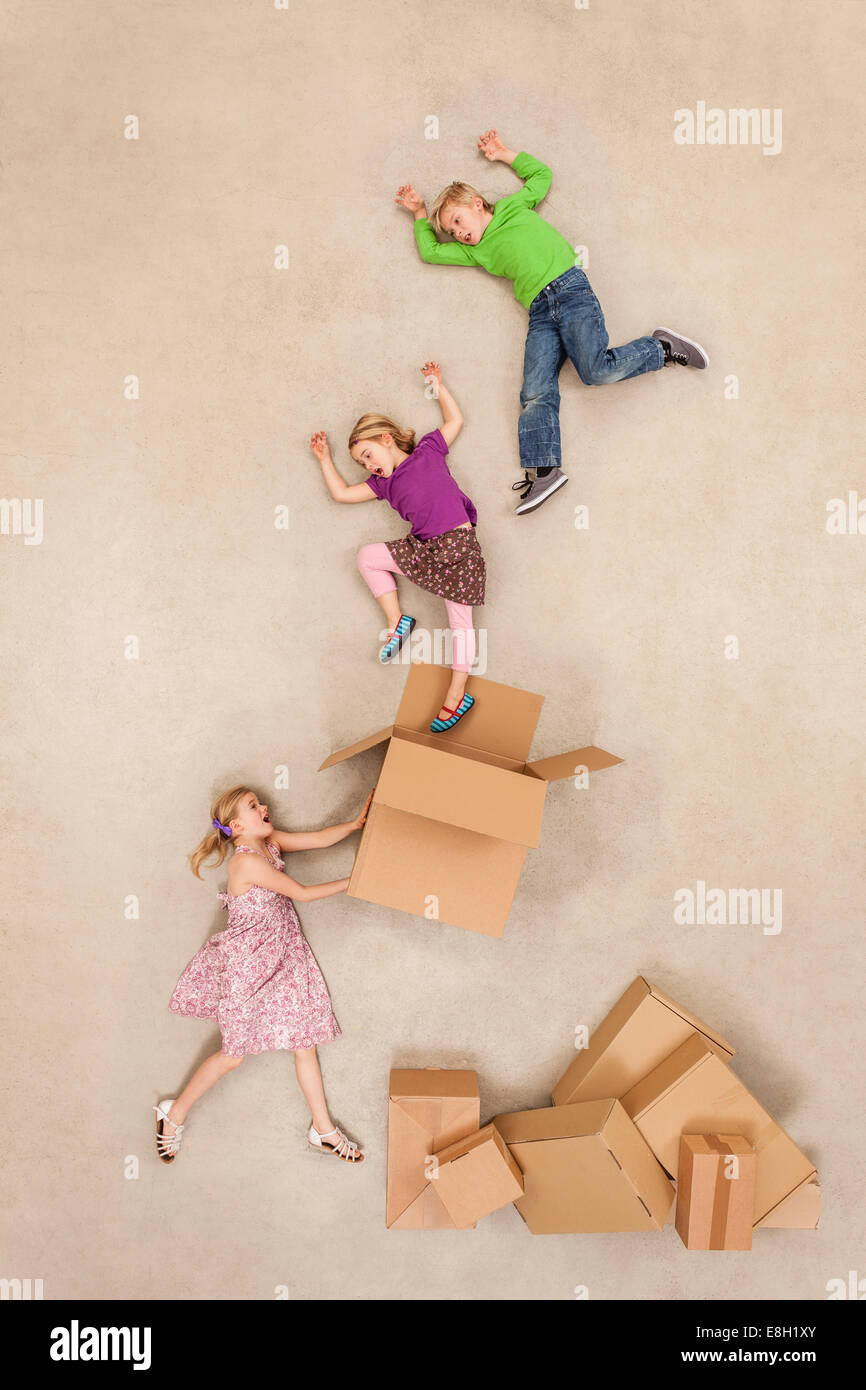 Children jumping out of cardboard boxes Stock Photo - Alamy