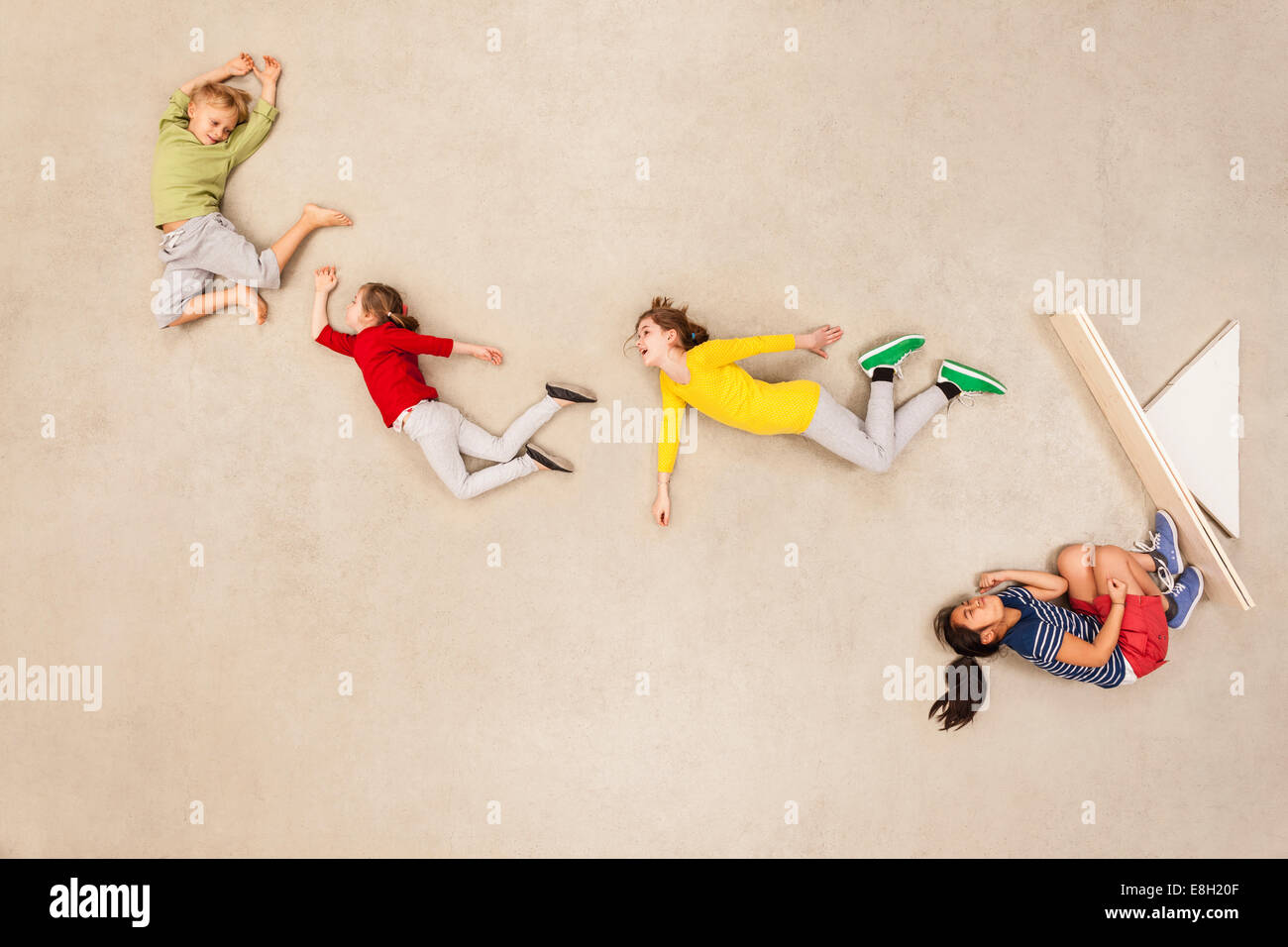 Children doing somersaults on seesaw Stock Photo - Alamy