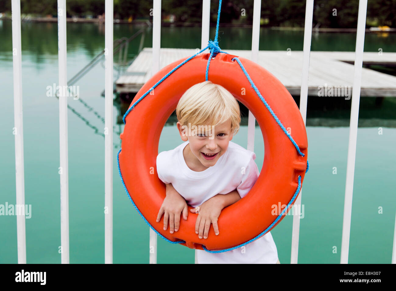 Portrait of smiling little boy looking through a lifesaver Stock Photo ...