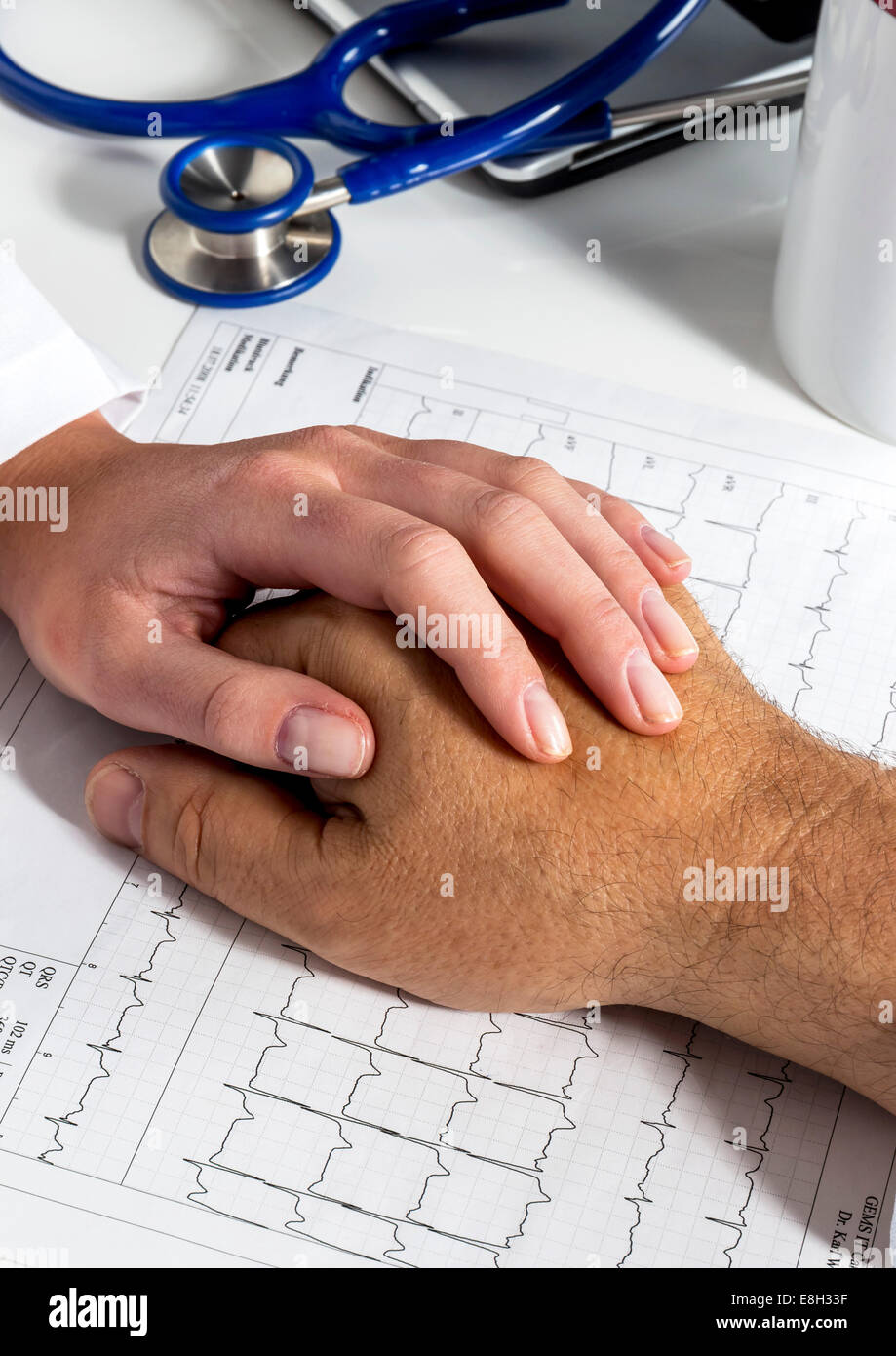 Doctor holding patient's hand Stock Photo - Alamy