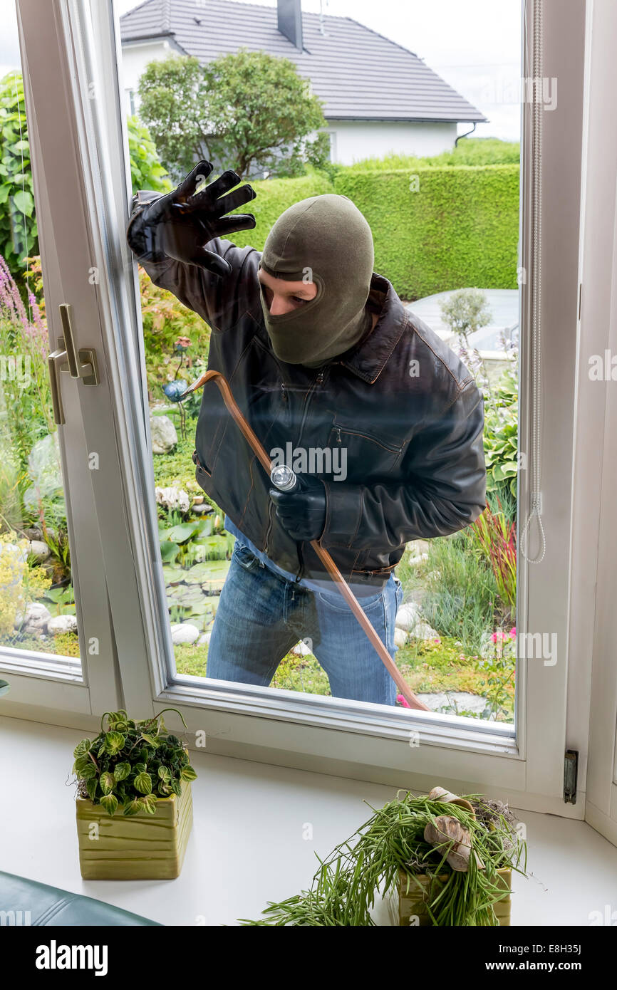 Burglar trying to get into house Stock Photo - Alamy