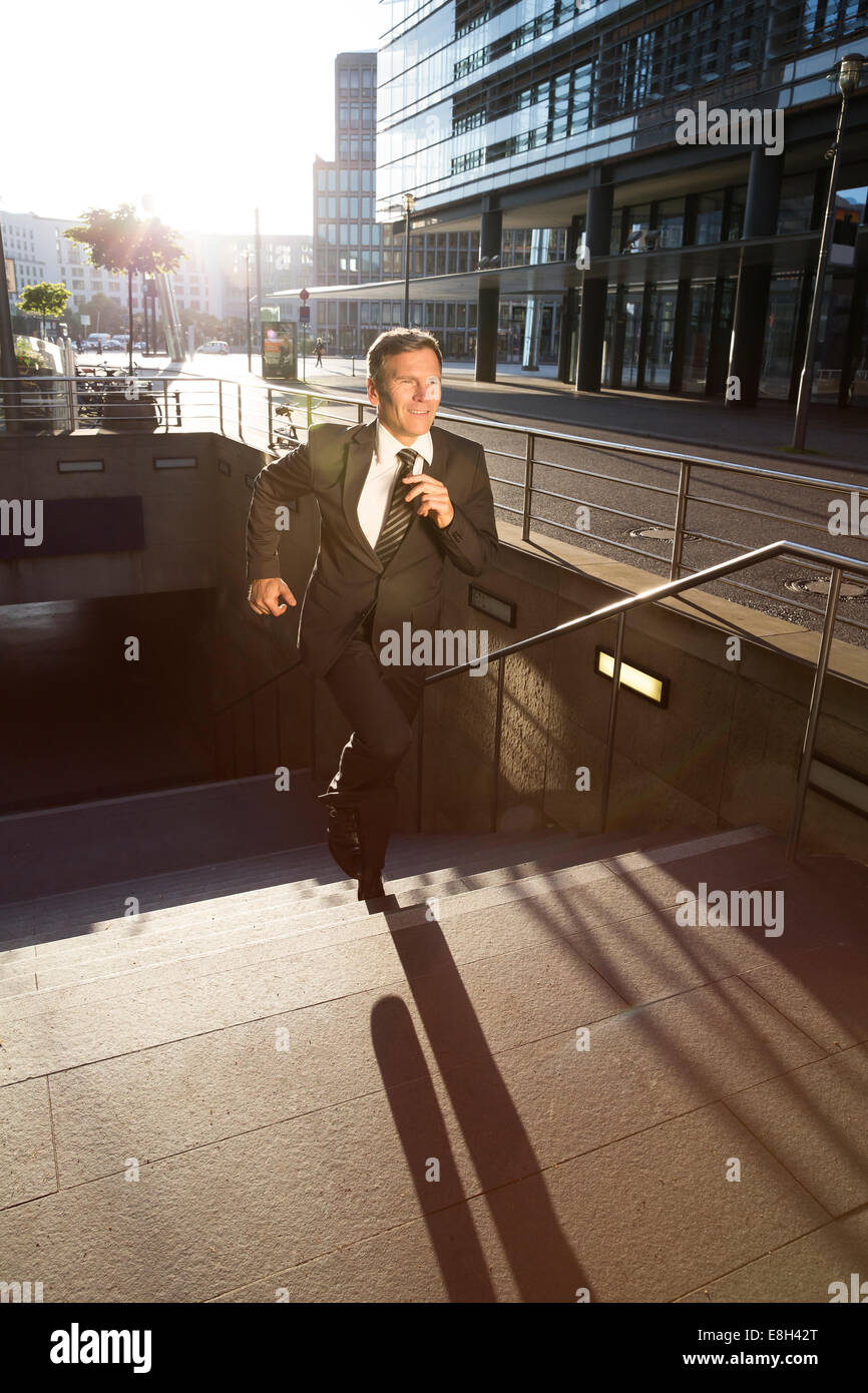 Germany, Berlin, Businessman running on stairs Stock Photo - Alamy