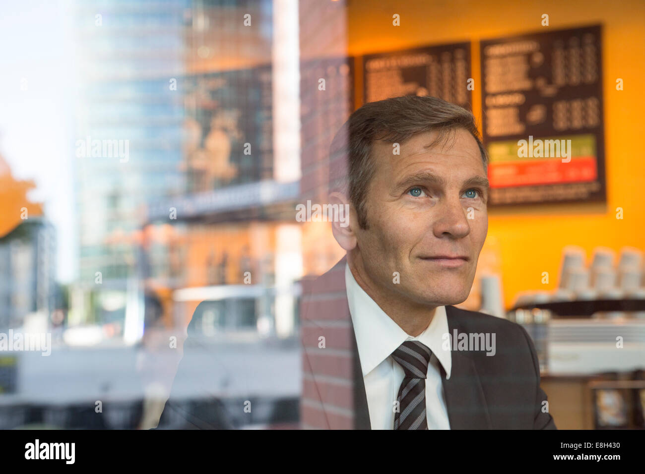 Germany, Berlin, Businessman in coffee shop, taking a break Stock Photo ...