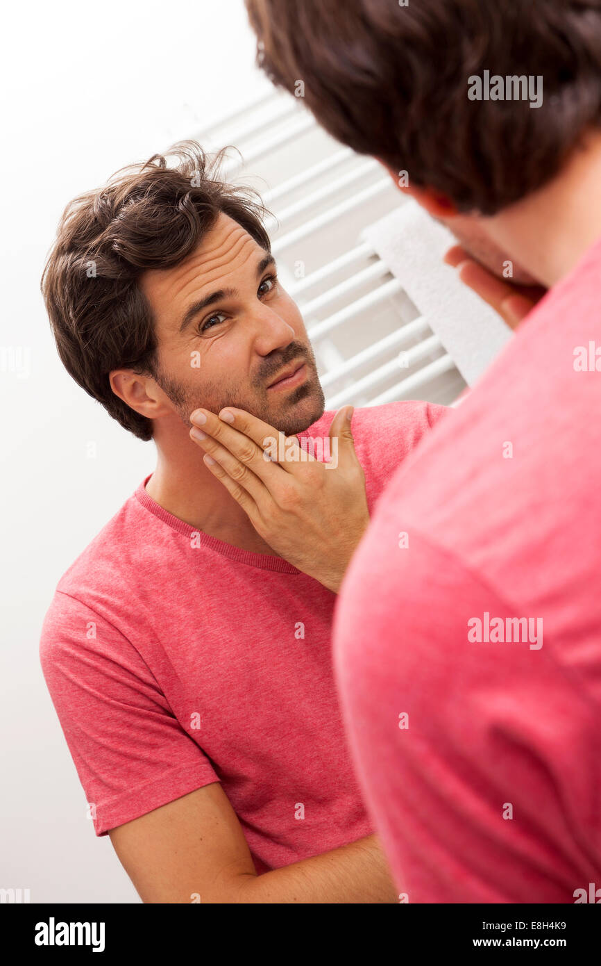 Mirror image of man watching himself Stock Photo - Alamy