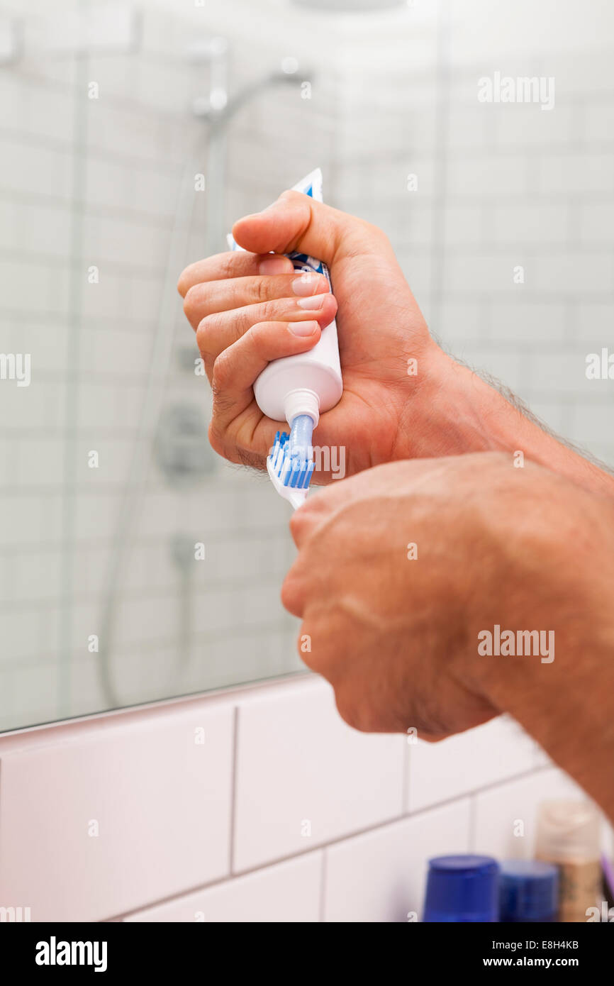 Man's hands applying toothpaste on a toothbrush Stock Photo - Alamy