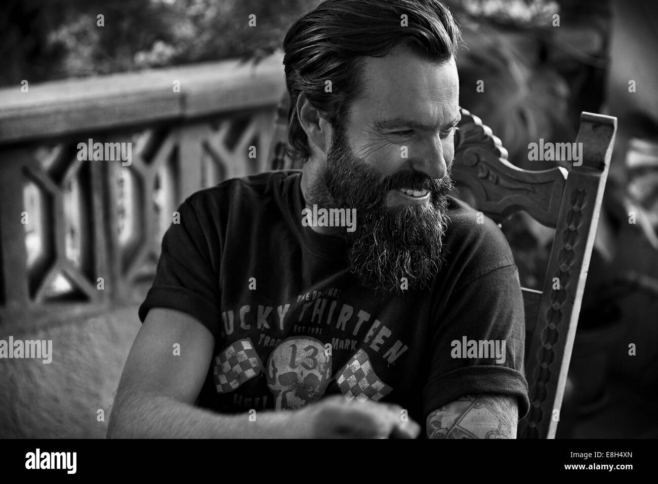 Smiling man with full beard Stock Photo - Alamy