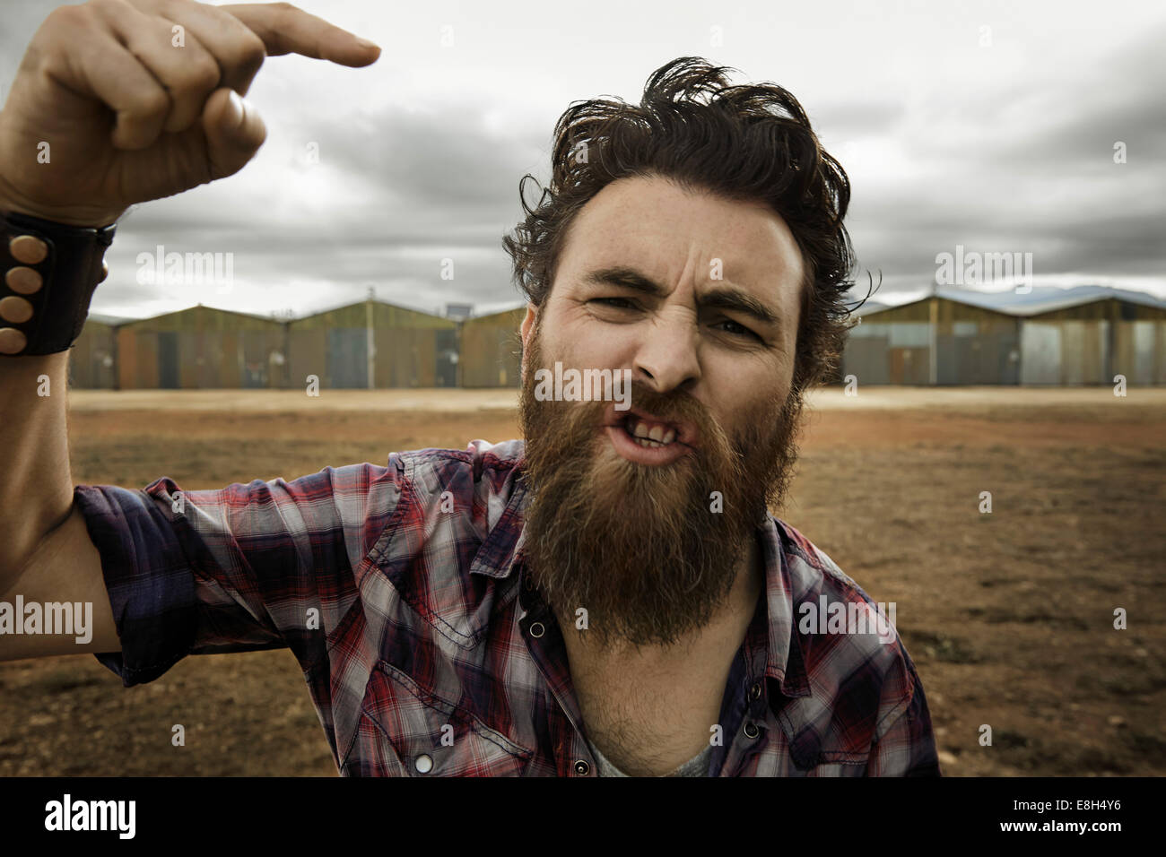 Angry man with full beard shouting at camera Stock Photo - Alamy