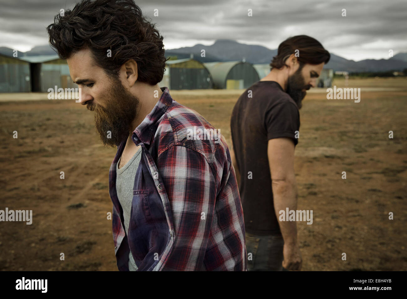 Two men with full beards in abandoned landscape Stock Photo - Alamy