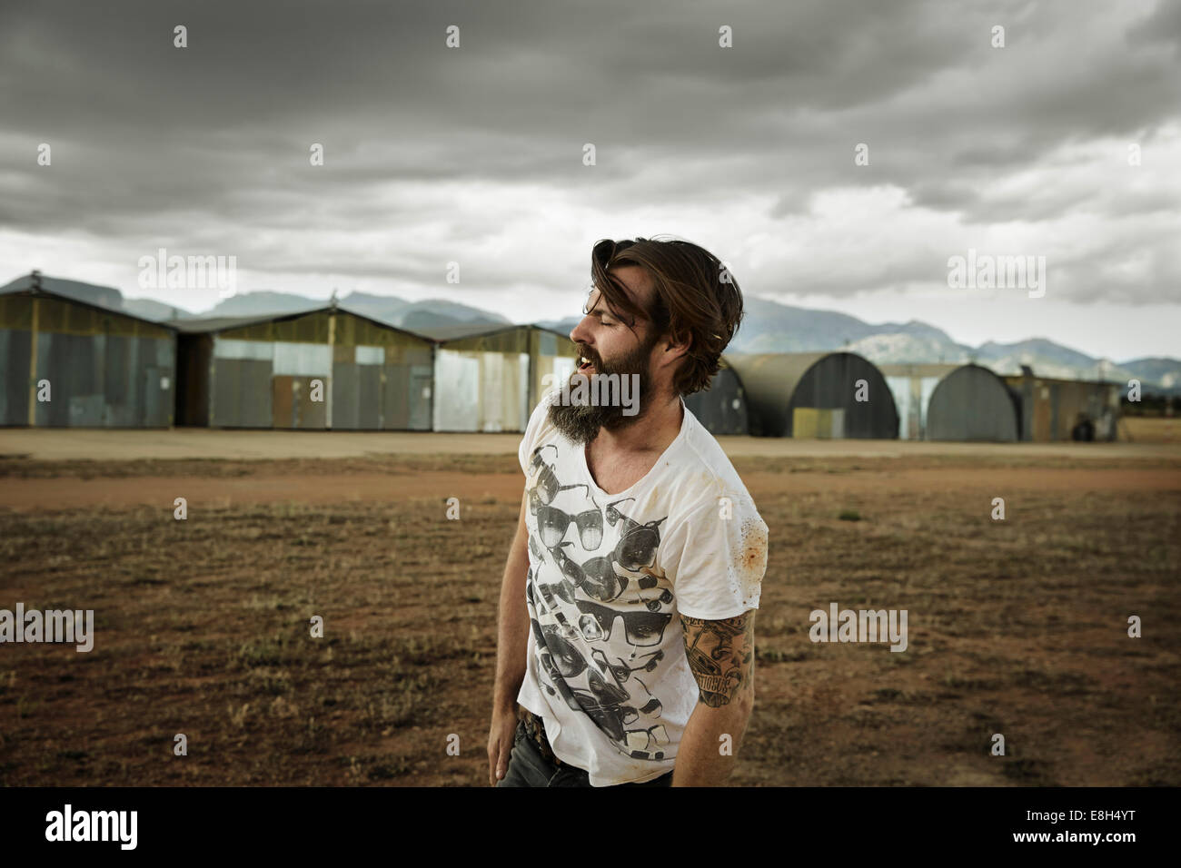 Man with full beard in abandoned landscape Stock Photo - Alamy