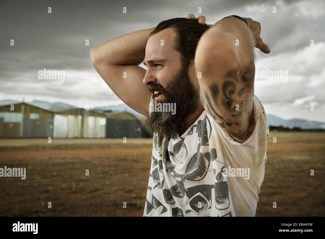 Man with full beard in abandoned landscape Stock Photo - Alamy