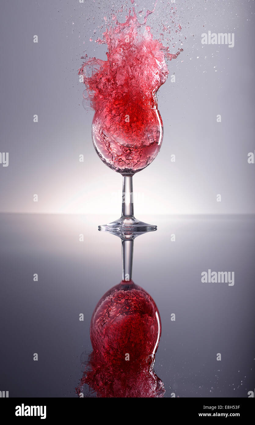 Red wine splashing in glass Stock Photo - Alamy