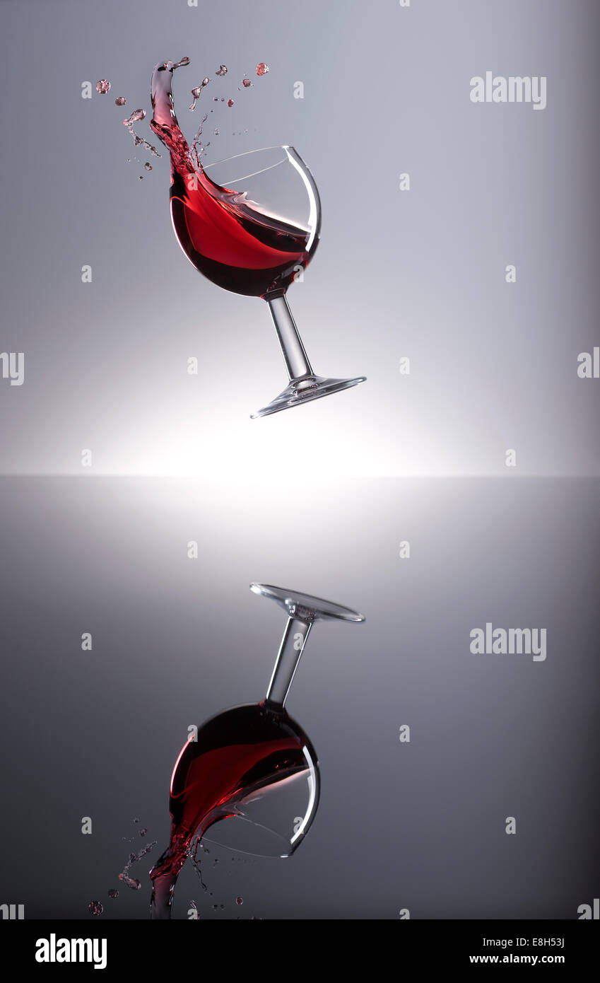 Red wine shaking in glass Stock Photo - Alamy