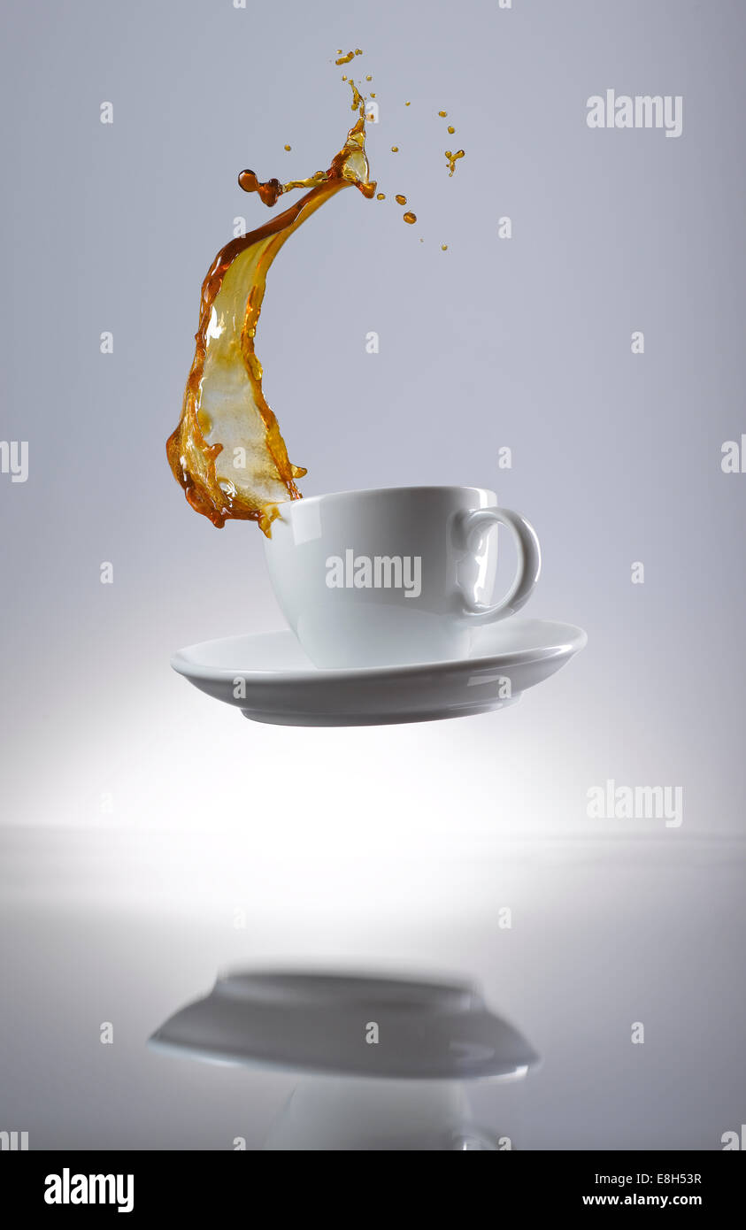 Coffee splashing in cup Stock Photo - Alamy