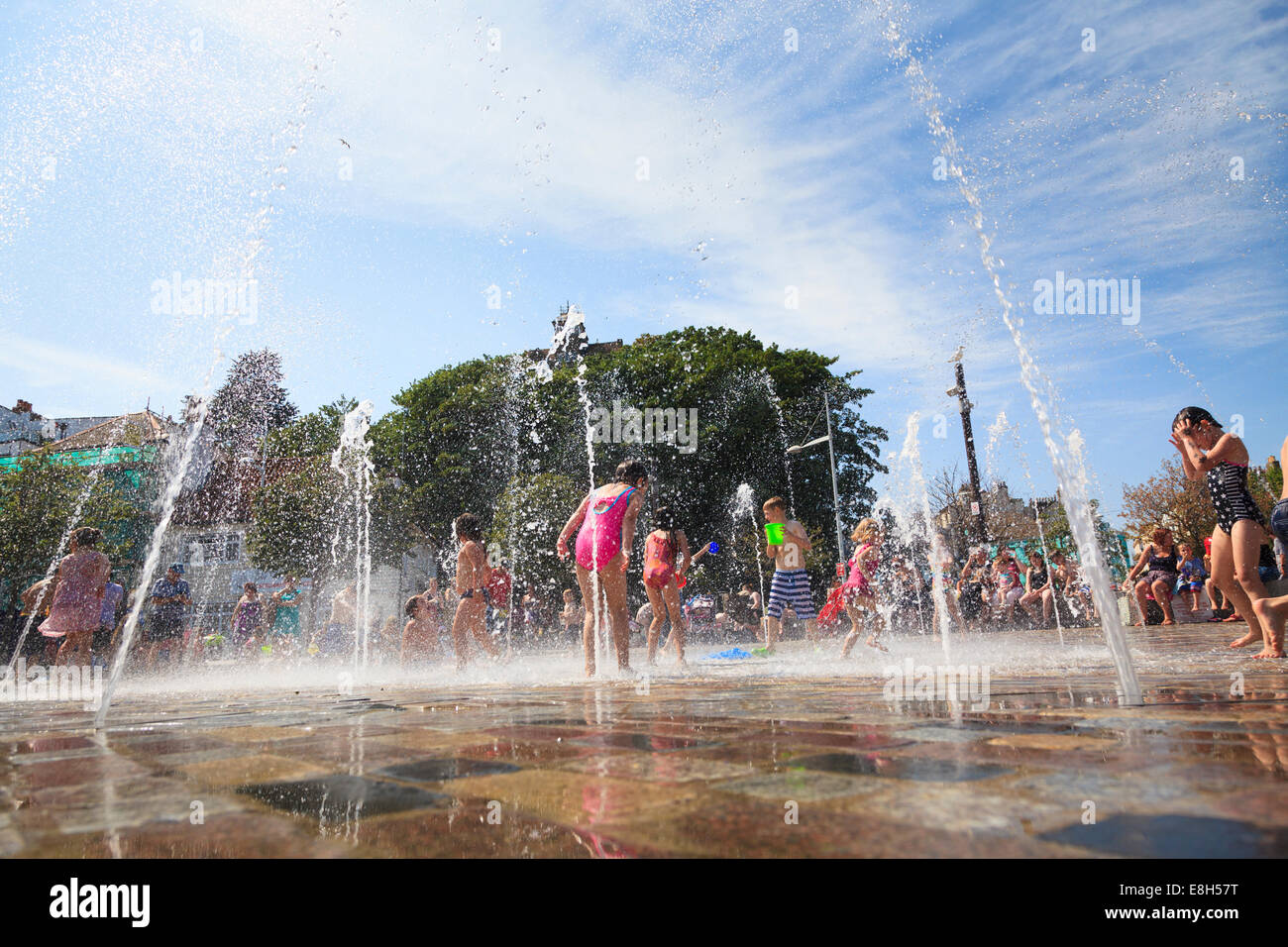 Families enjoying the water spout fountains near the harbour at ...