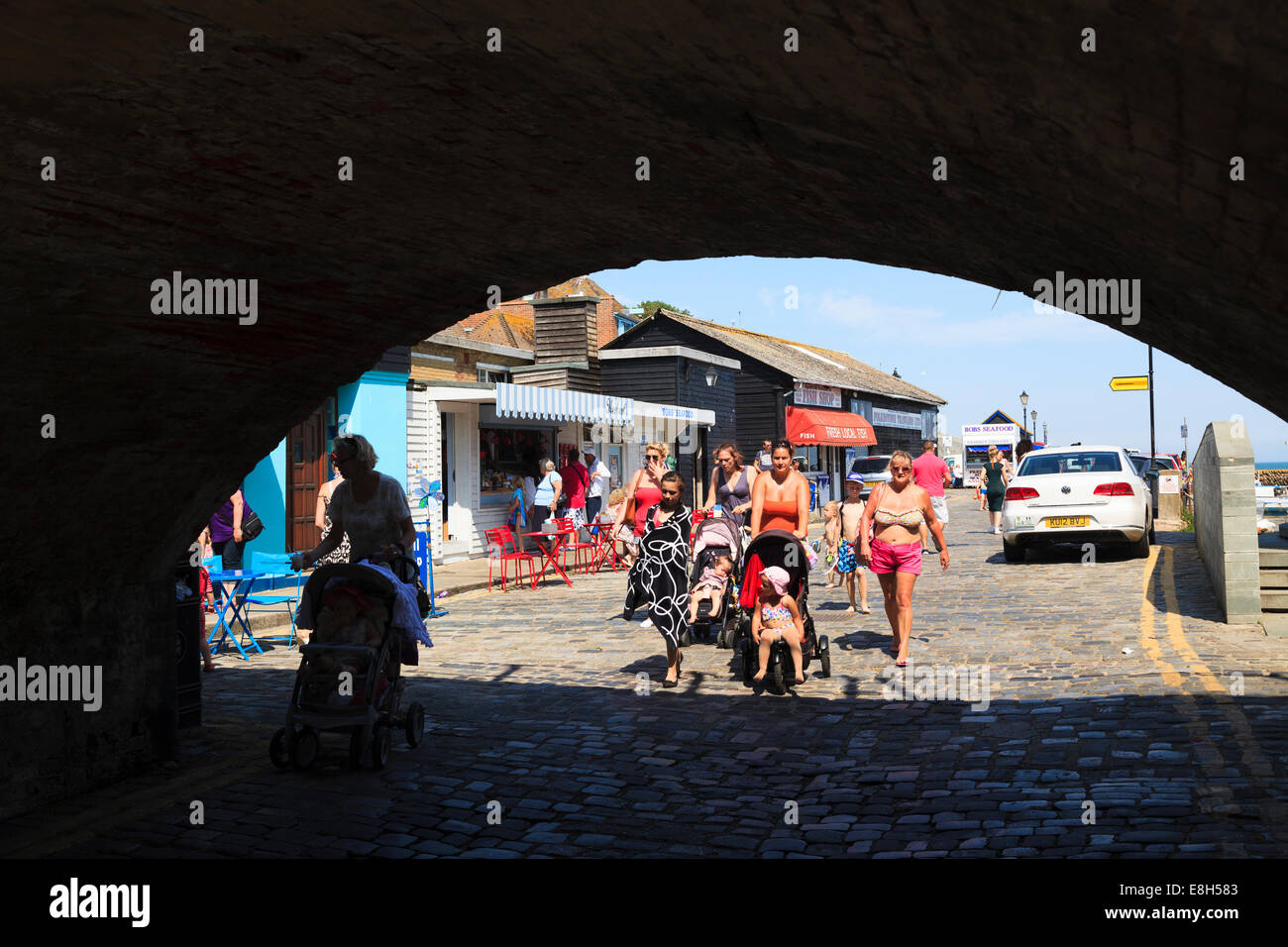 People walking under the arch at Folkestone fish market Stock Photo - Alamy