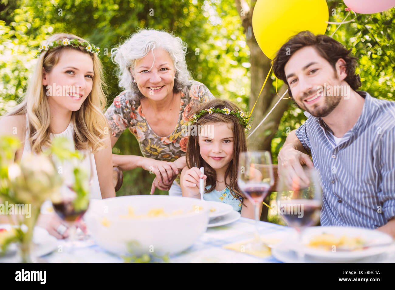 Portrait of happy family of three generations on a garden party Stock ...