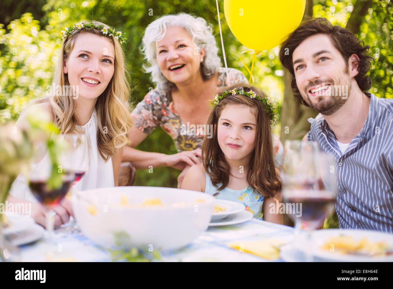 Happy family of three generations on a garden party Stock Photo - Alamy