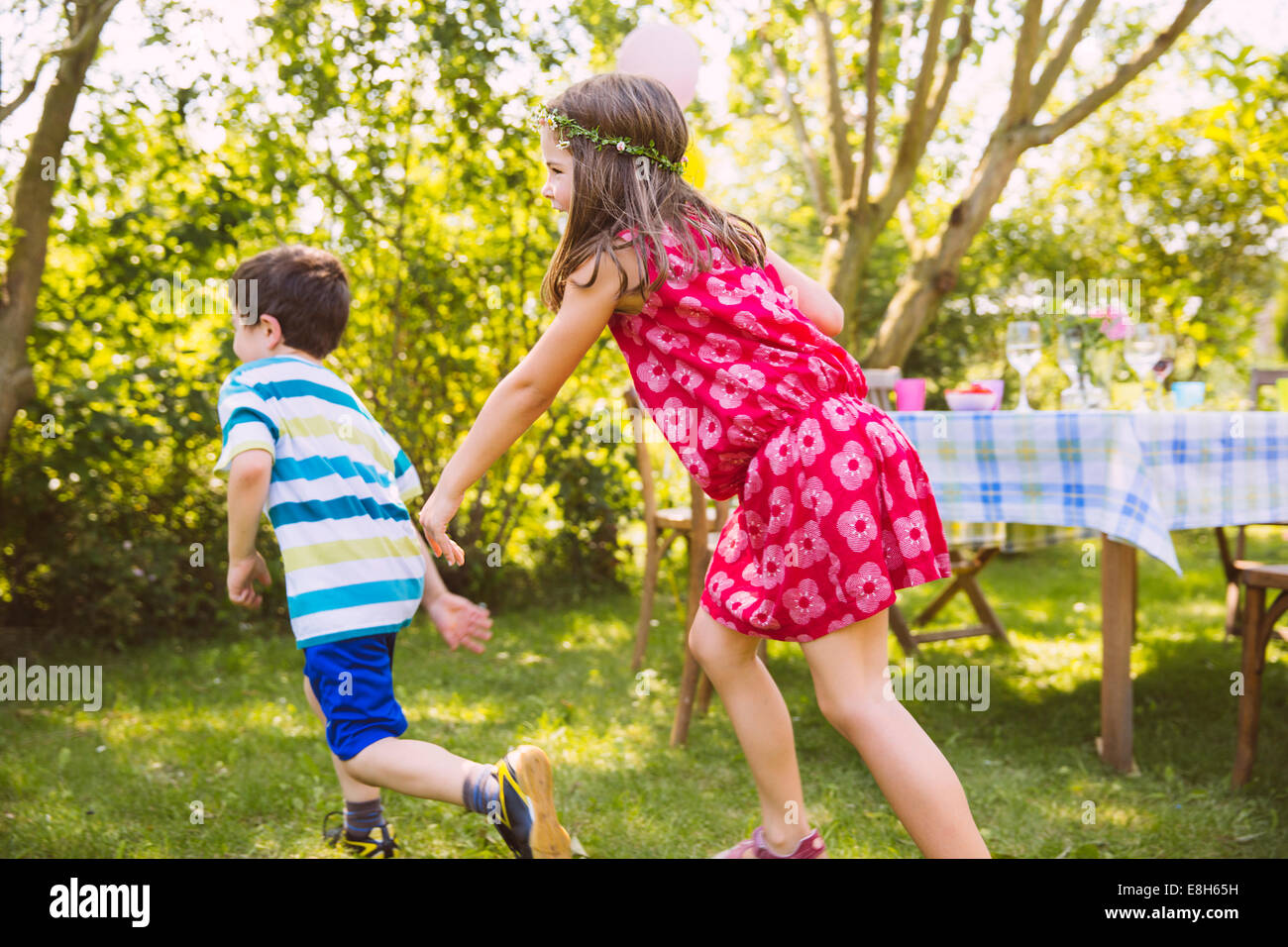 Boy girl playing tag in hi-res stock photography and images - Alamy