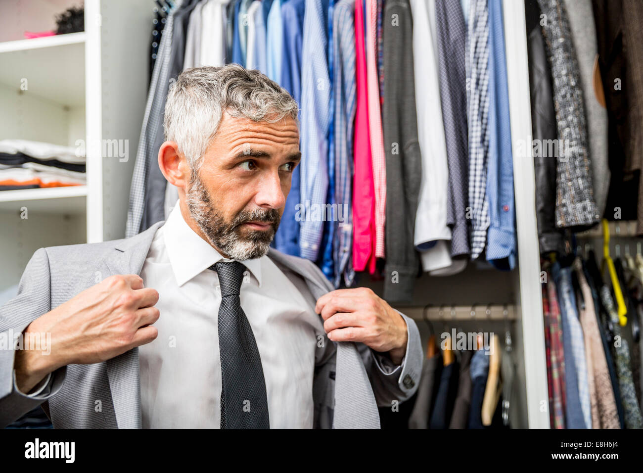 Businessman dressing at his walk-in closet Stock Photo - Alamy