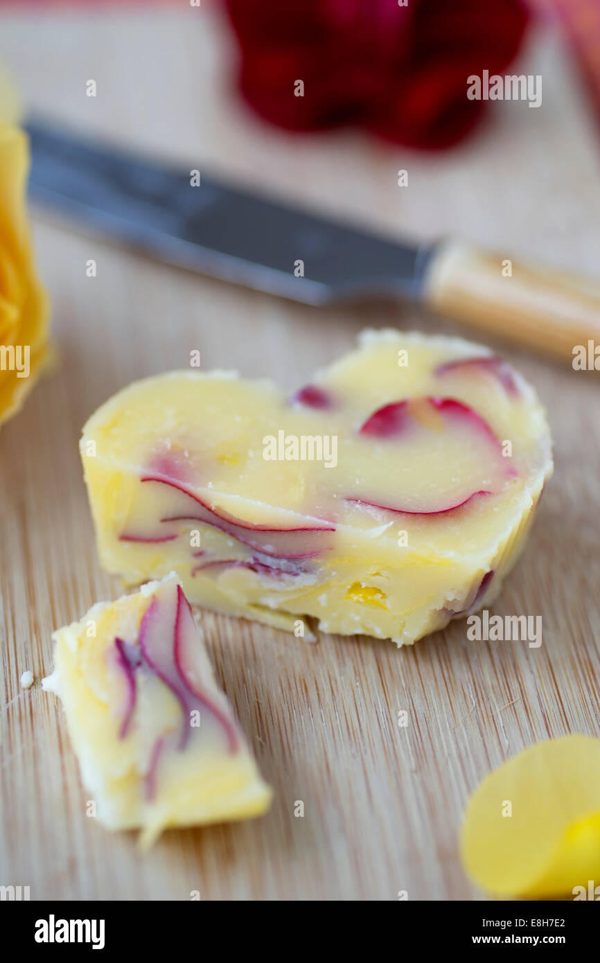 Rose butter and rose petals on chopping board Stock Photo - Alamy