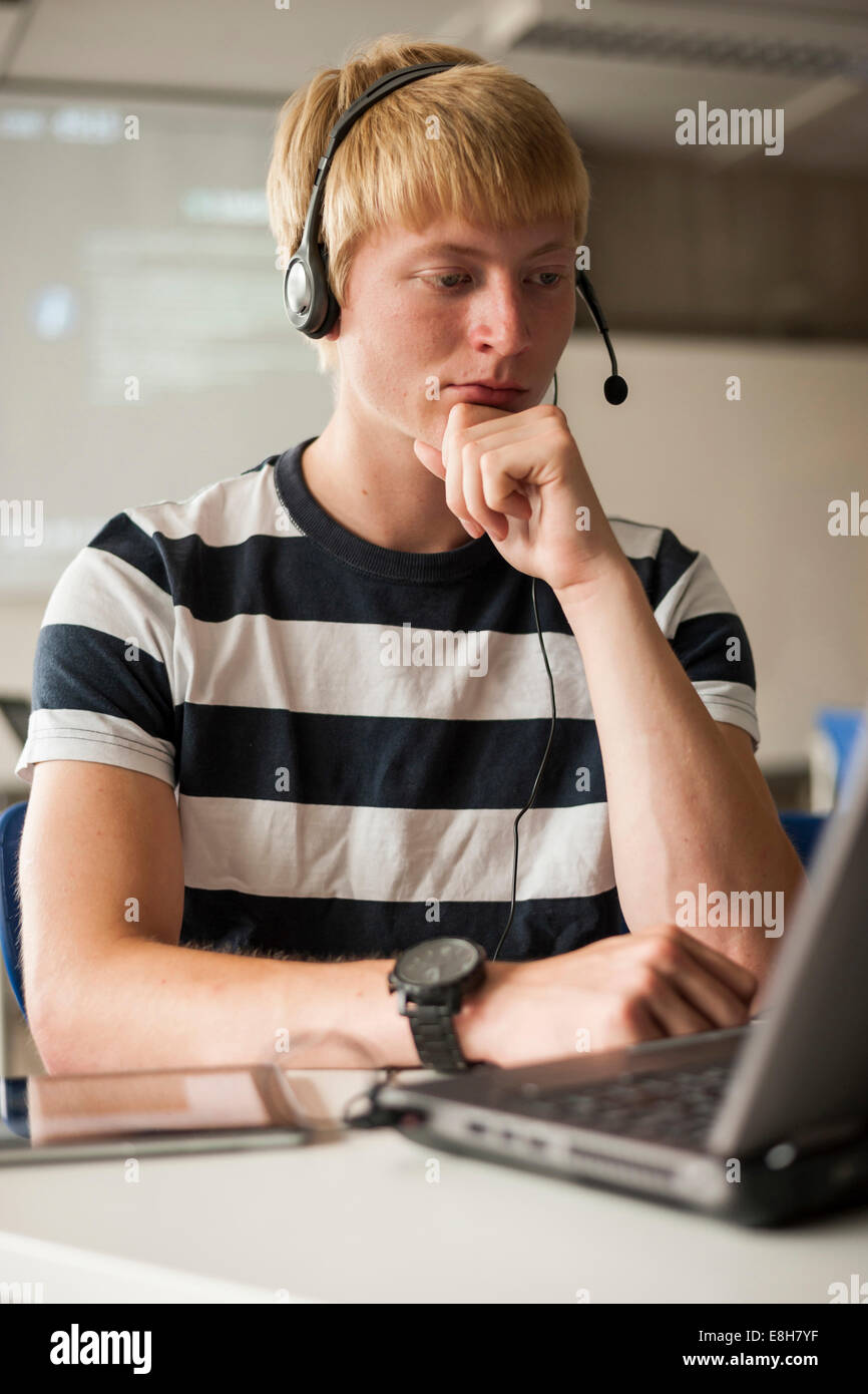 Vocational school student with headset in computer lab Stock Photo - Alamy