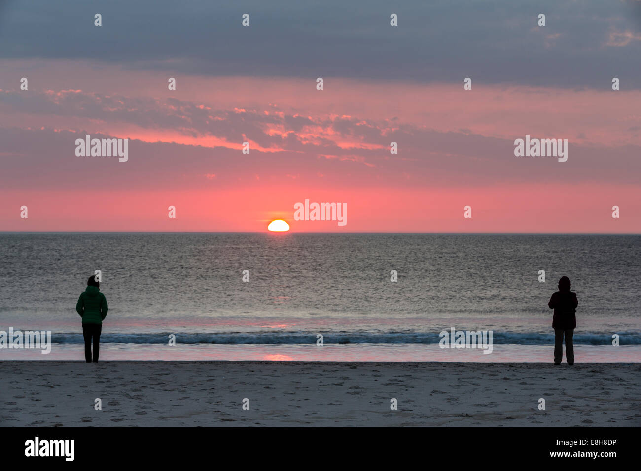 Germany, Schleswig-Holstein, Sylt, sunset on the beach, two people ...