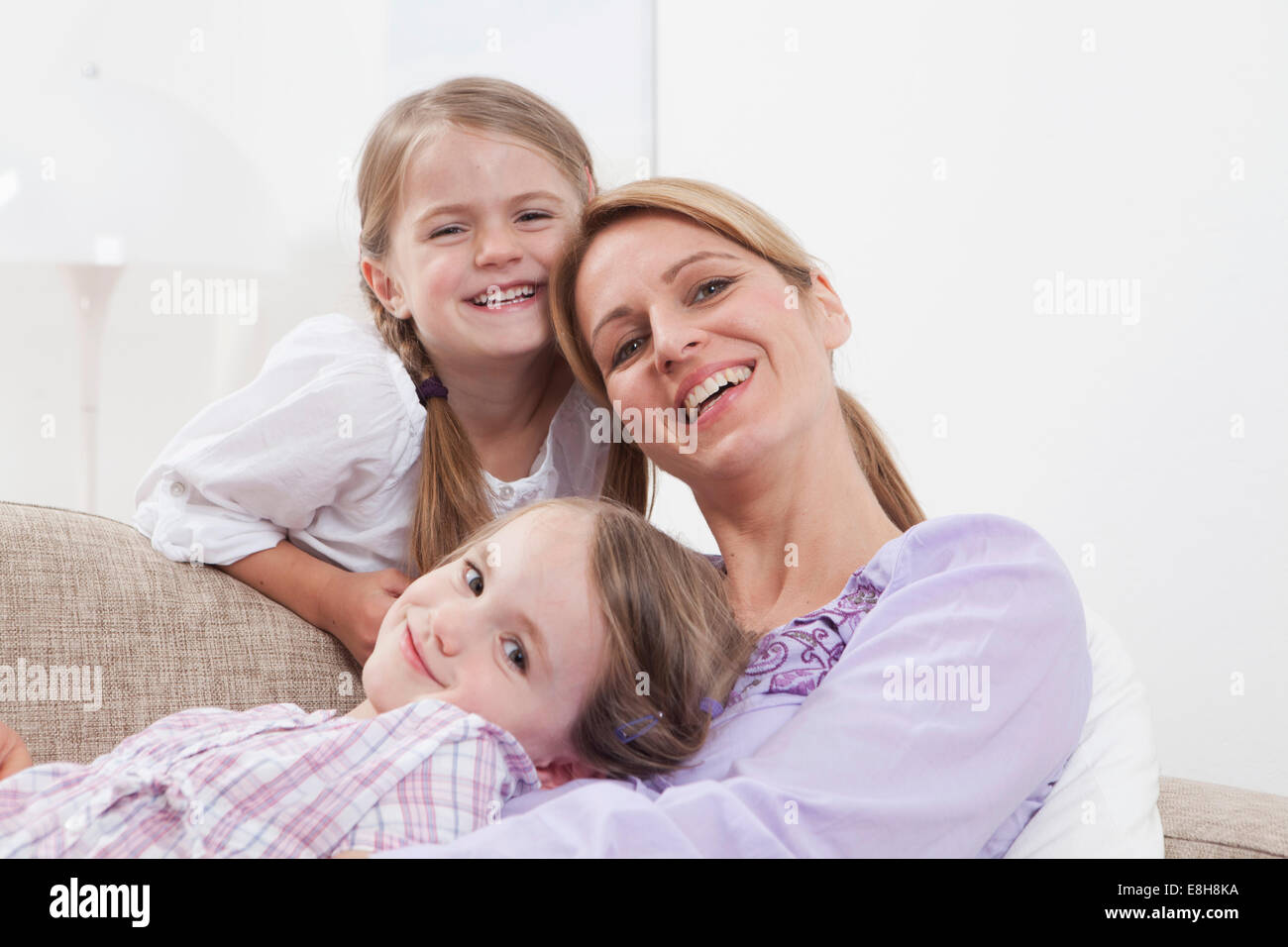 Germany, Munich, Mother with daughters (4-7) smiling, portrait Stock ...