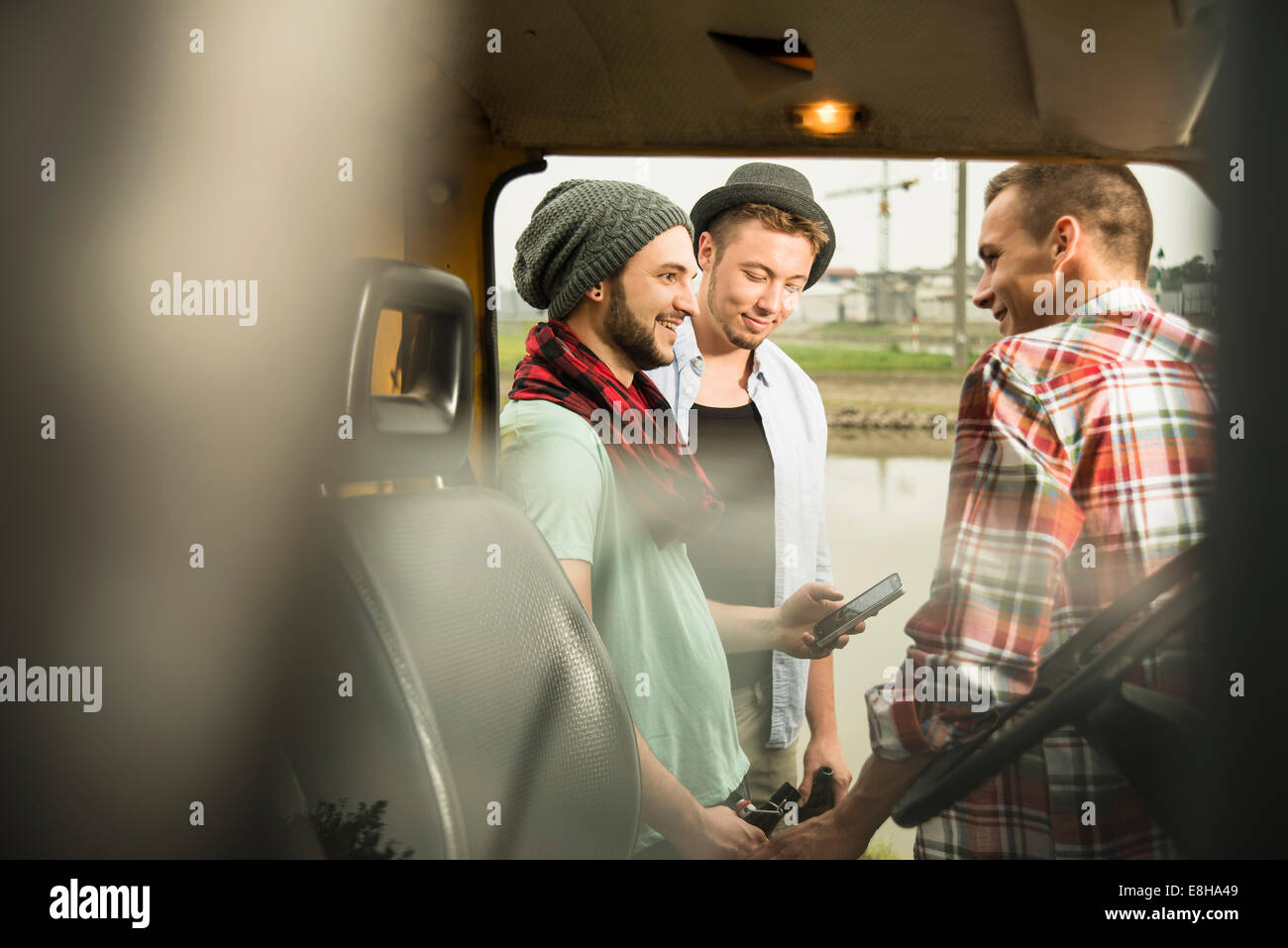 Group of friends with cell phone at a car Stock Photo - Alamy