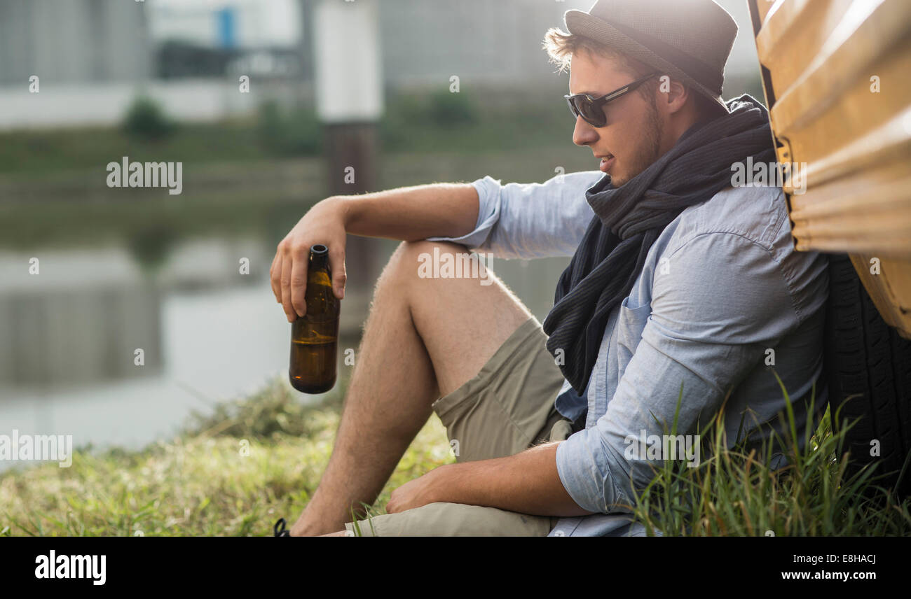 Man bottle beer leaning against hi-res stock photography and images - Alamy