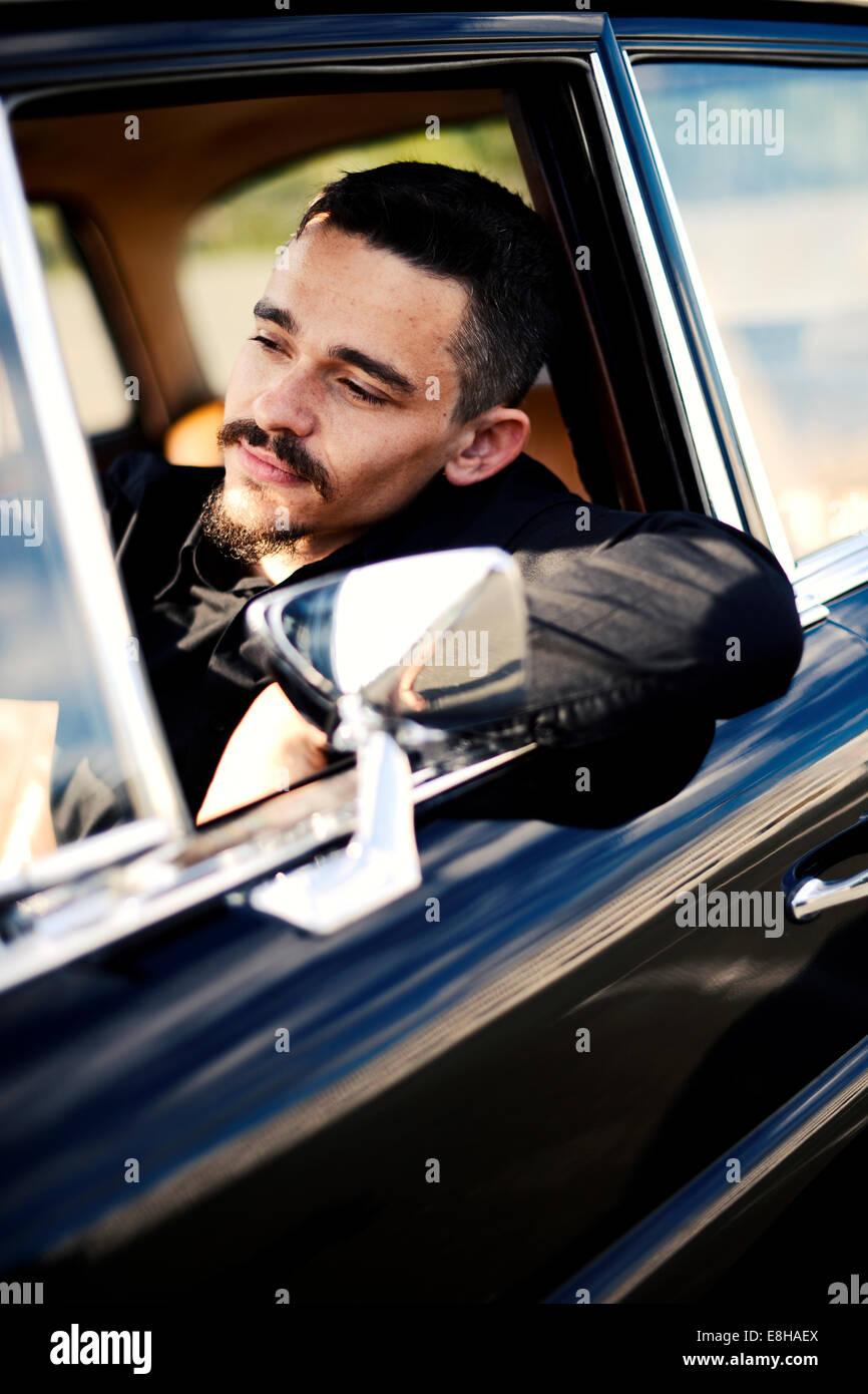 Young man inside vintage car Stock Photo - Alamy