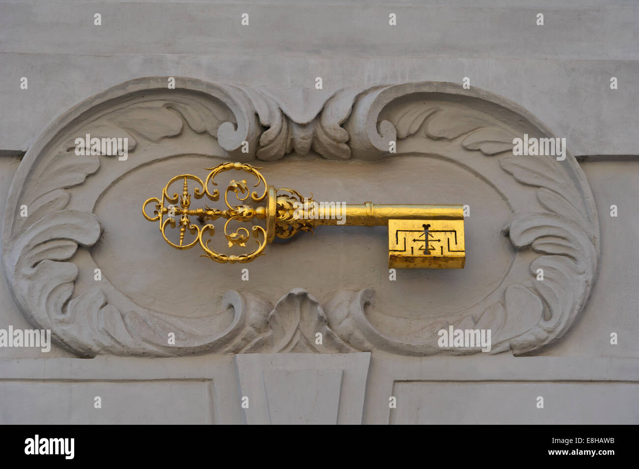 A small golden key on the exterior of the wall of a building in the ...