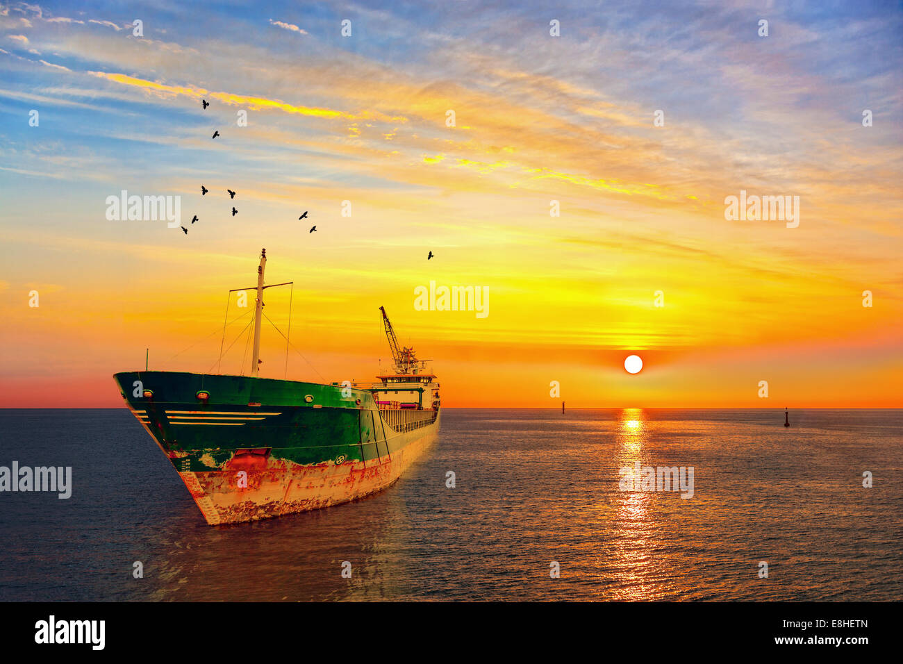 Beautiful sunrise with a dry cargo ship at sea Stock Photo - Alamy