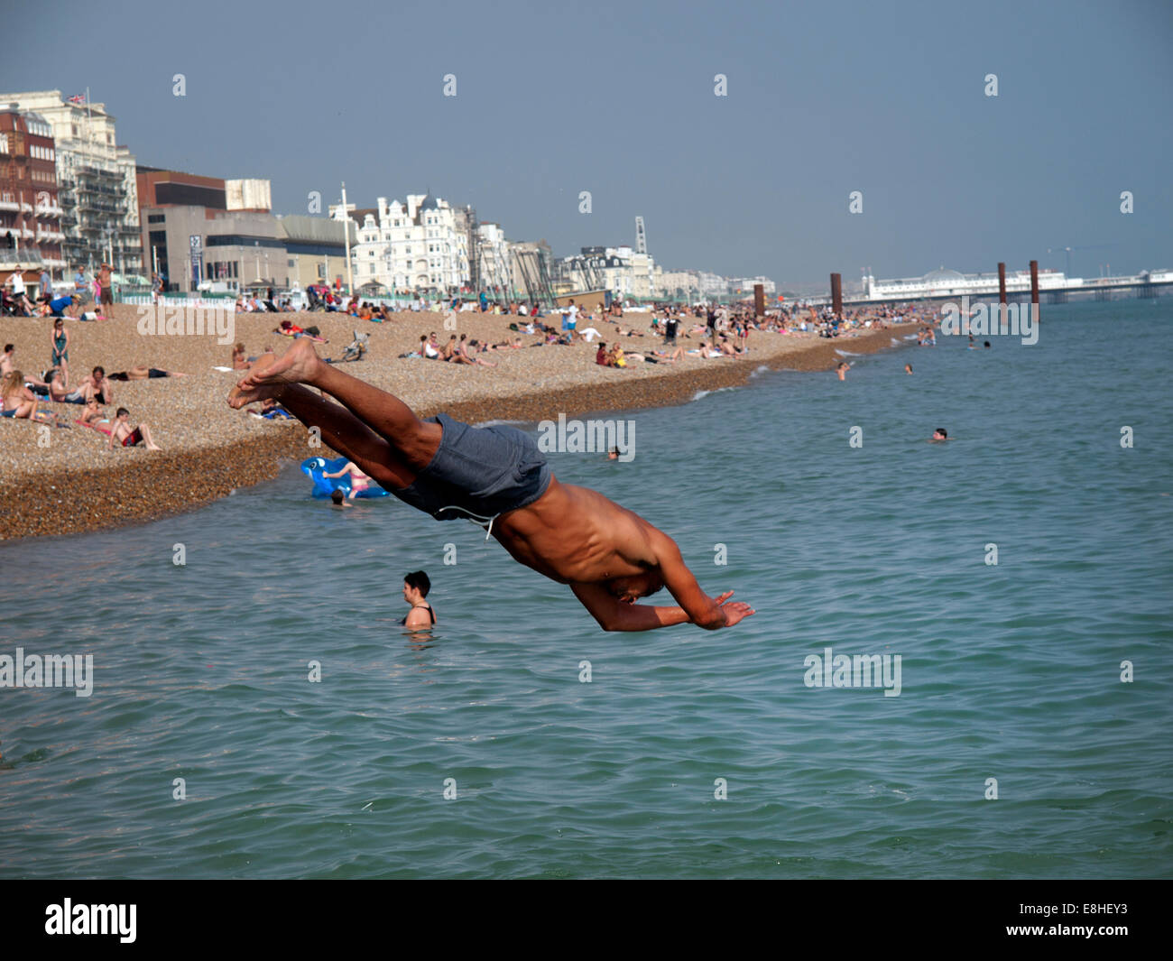Jumping into the sea in Brighton Stock Photo - Alamy