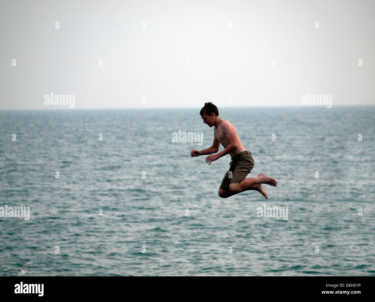 Boy diving into sea hi-res stock photography and images - Alamy