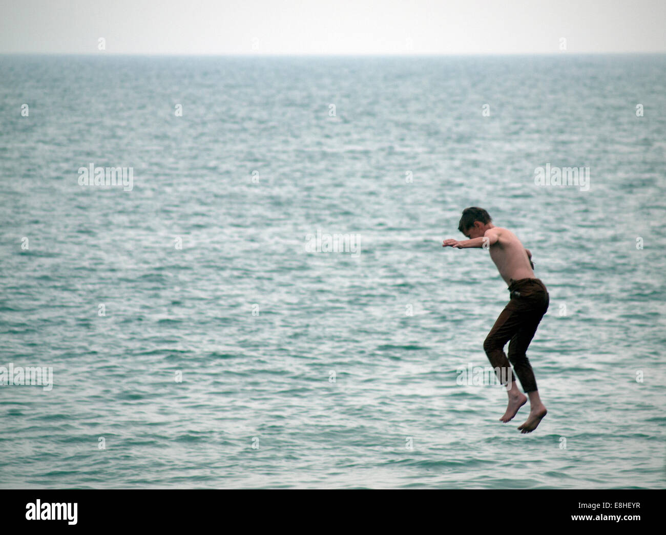 Jumping into the sea in Brighton Stock Photo - Alamy