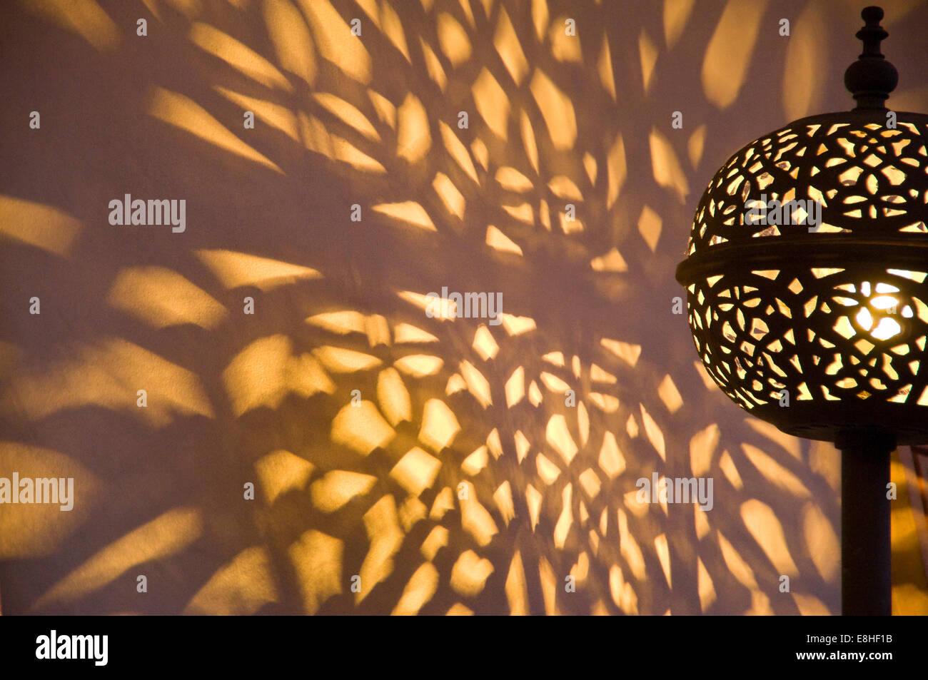 Horizontal close up of a traditional metal lampshade casting shadows on ...
