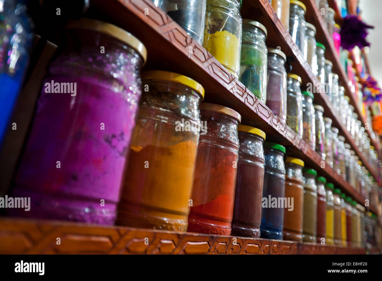 Horizontal close up of colourful jars of pigment in a shop in the souks ...