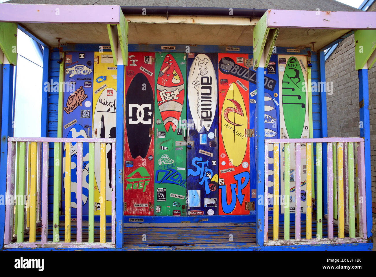 The front of a colorful surfing beach hut on the promenade at ...