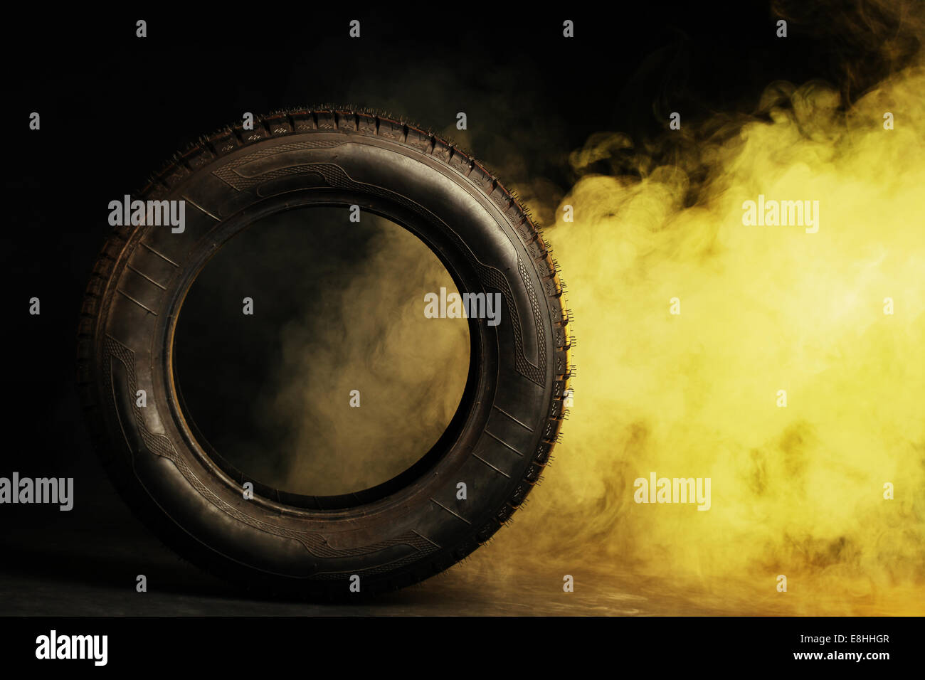 photo of black smoked burning tire Stock Photo - Alamy