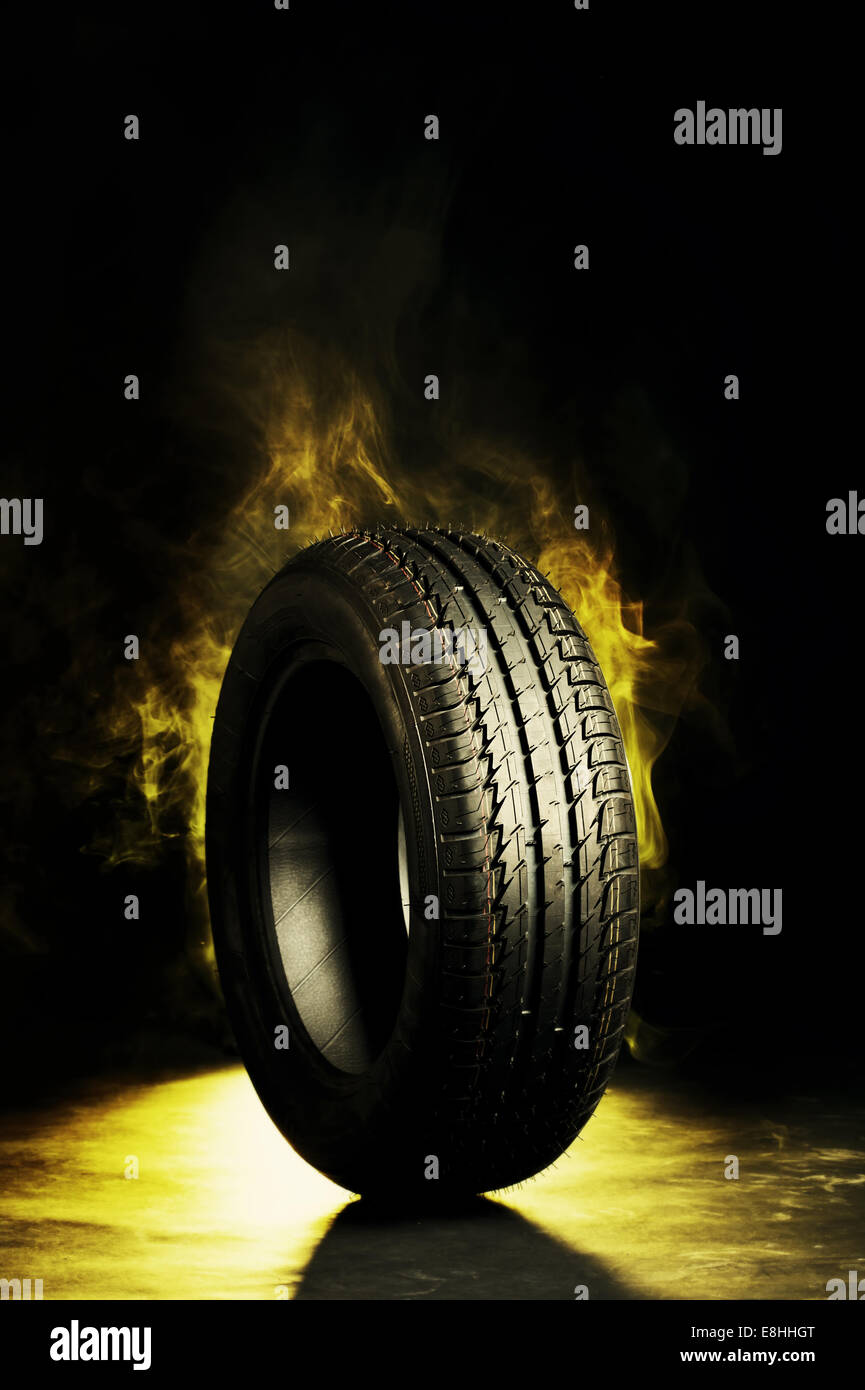 photo of black smoked burning tire Stock Photo - Alamy
